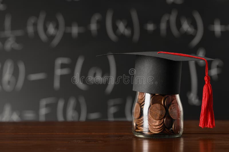 Scholarship Concept. Graduation Cap and Jar with Coins on Wooden Table ...