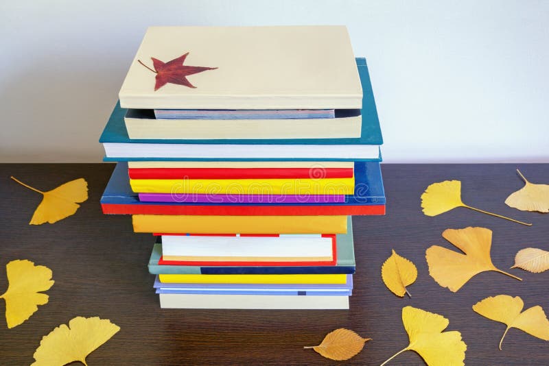 School and Autumn Concepts. Stack of Different Books and Autumn Leaves ...