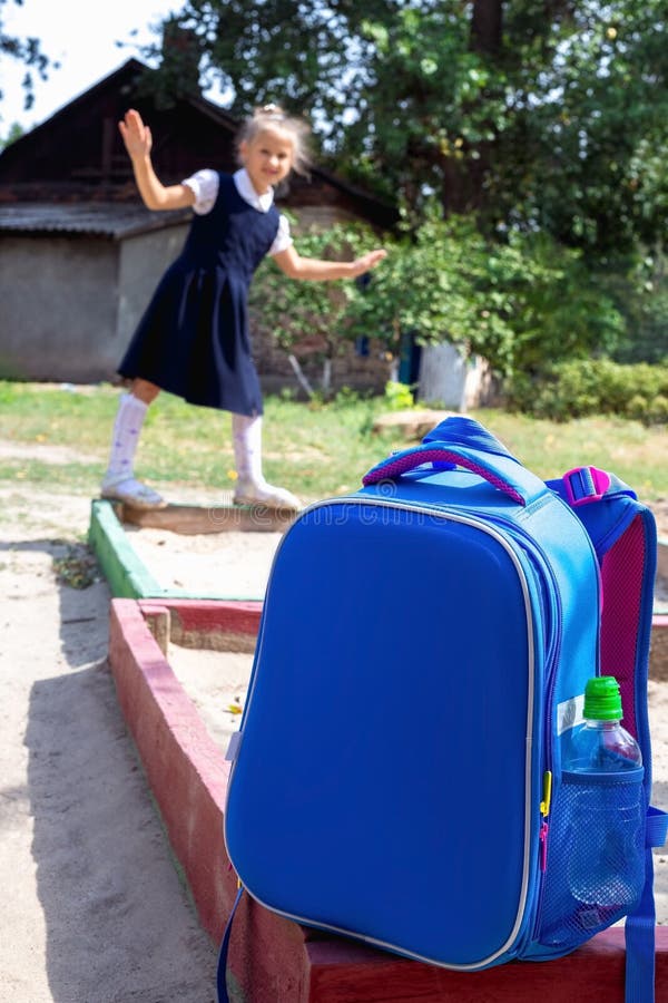 School Bag and an Elementary Student on Playground Stock Photo - Image ...