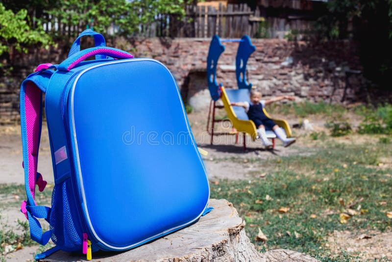 School Bag and an Elementary Student on Playground Stock Image - Image ...