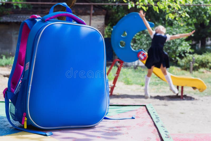 School Bag and an Elementary Student on Playground Stock Image - Image ...