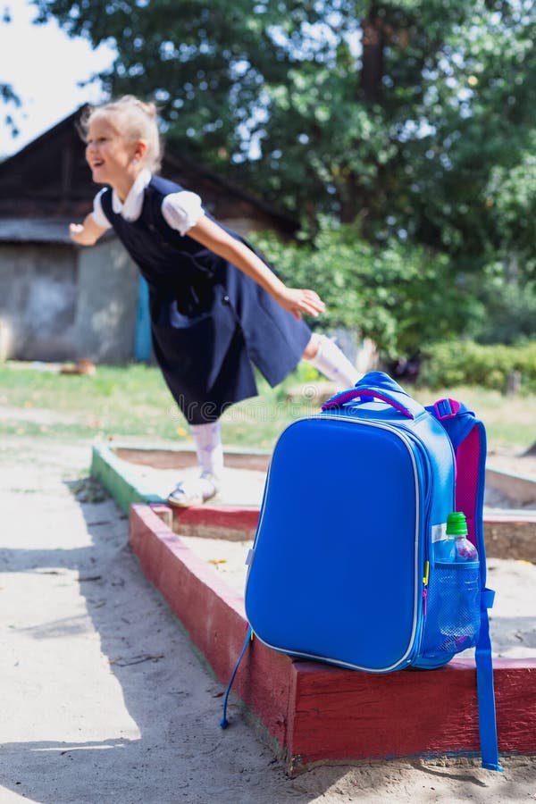 School Bag and an Elementary Student on Playground Stock Image - Image ...