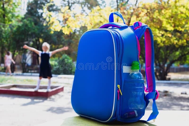 School Bag and an Elementary Student on Playground Stock Image - Image ...