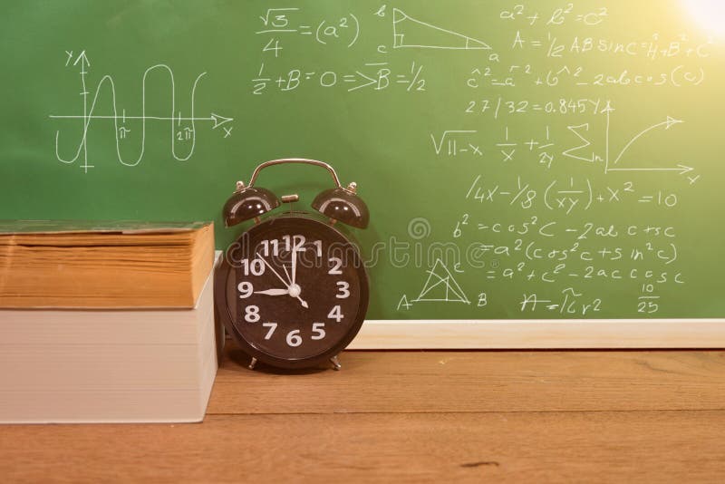 School Books and Clock on Desk with Green Board, Education Stock Photo ...