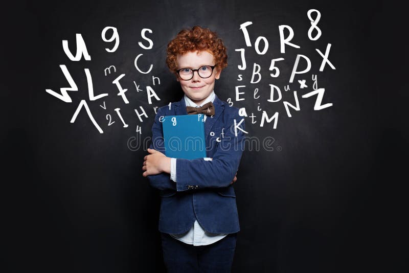 School Boy in Blue Student Uniform with Book on Blackboard Background ...