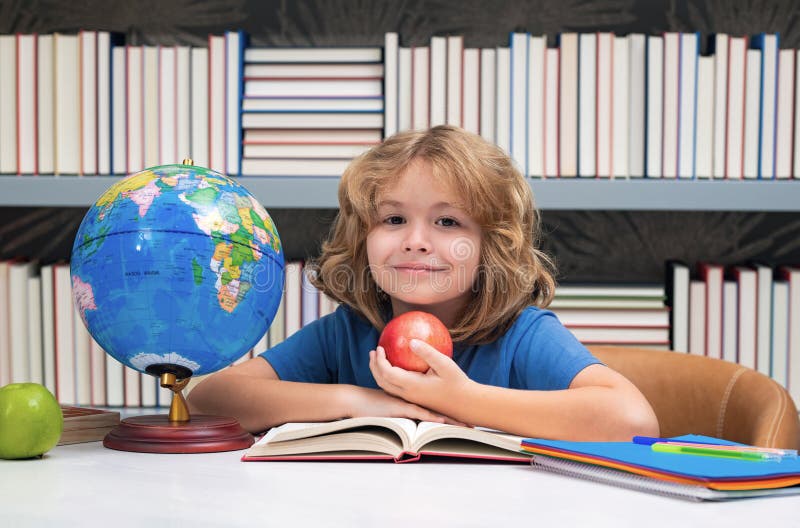 School Boy with Books and Apple in Library. School Child Student ...