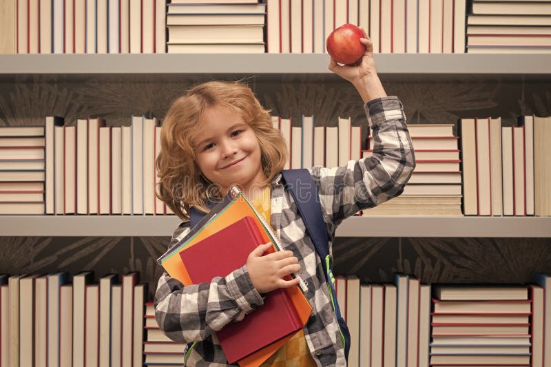 School Boy with Books and Apple in Library. Nerd School Kid. Clever ...