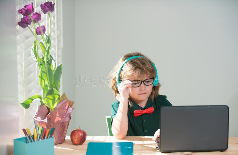 School Boy Doing Her Homework with Laptop. Child Using Gadgets To Study ...