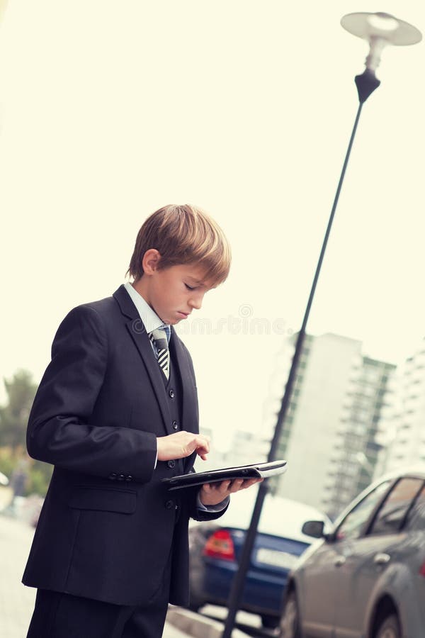 School Boy with Electronic Tablet Stock Photo - Image of outdoor, suit ...