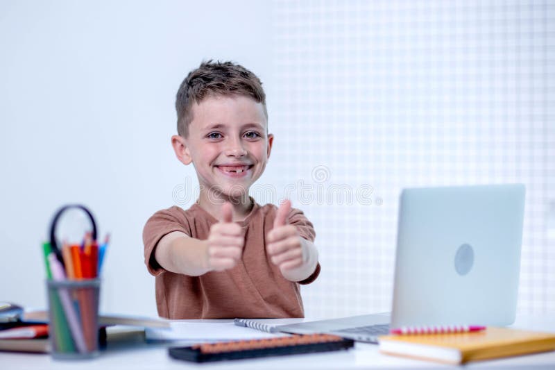 School Boy Enjoys Studying at Home with Laptop. Home Distance Learning ...