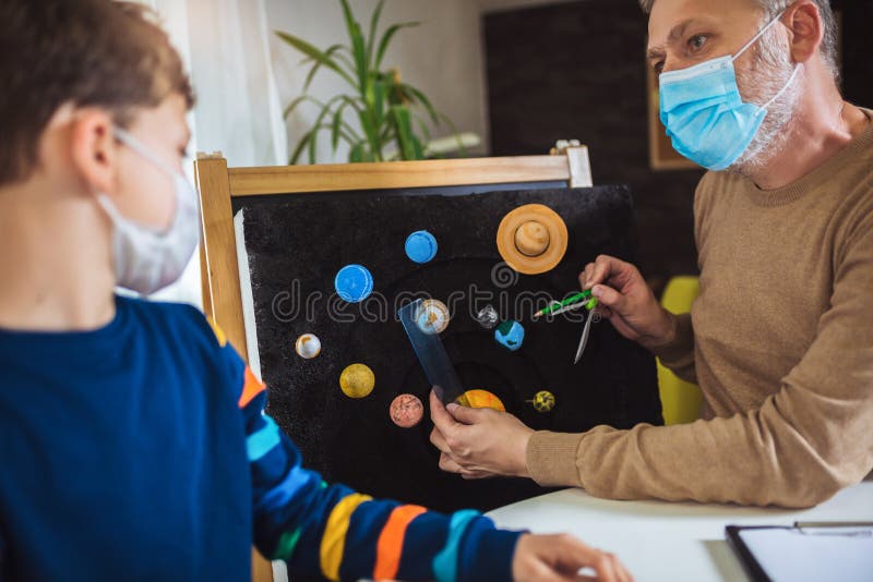 School Boy and His Father Making a Solar System for a School Science ...