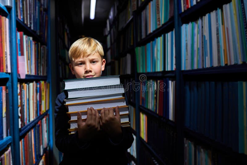 Little School Boy Taking Books from Shelves in Library, with a Stack of ...
