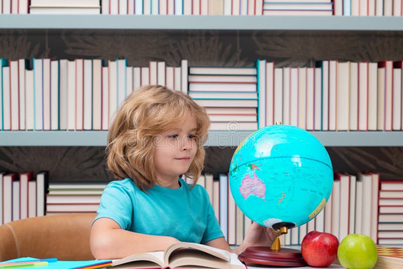 School Boy Looking at Globe in Library, Geography Lesson. School Child ...