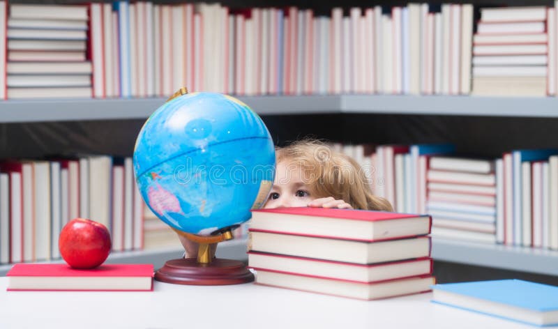 School Boy Looking at Globe in Library, Geography Lesson. School Child ...