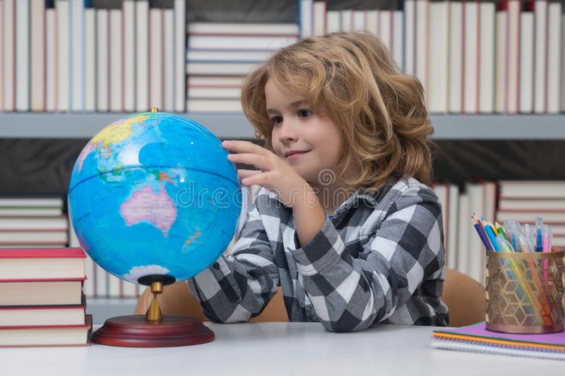 School Boy Looking at Globe in Library, Geography Lesson. School Child ...