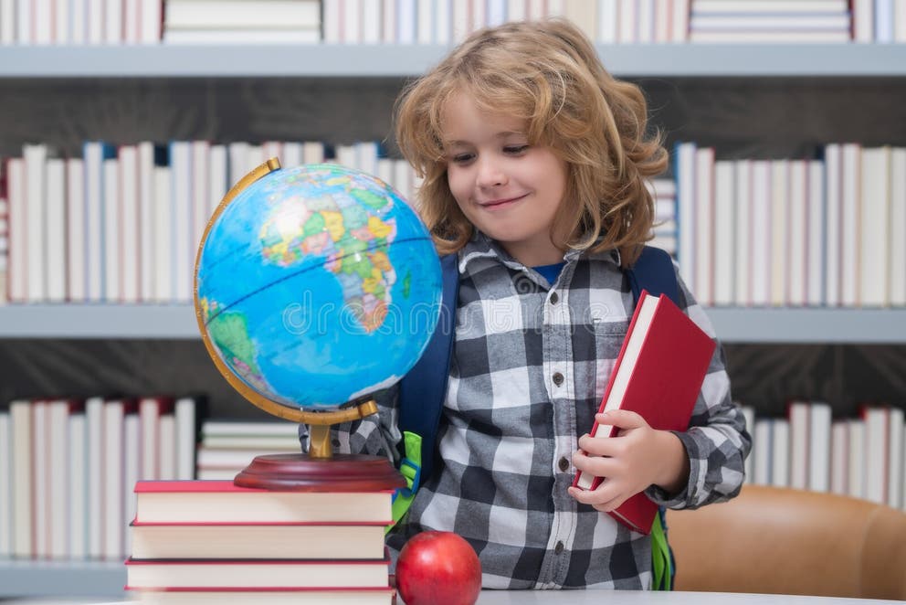 School Boy Looking at Globe in Library, Geography Lesson. School Child ...