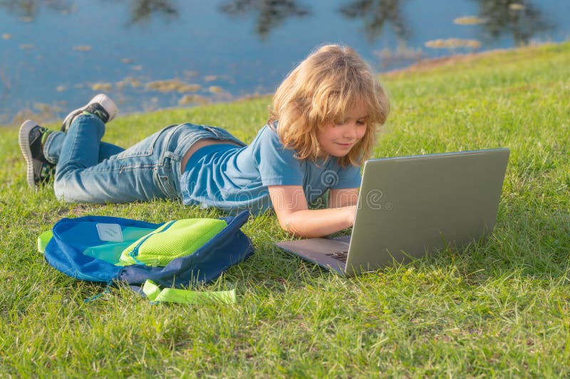 School Boy in Park Outdoor Doing School Homework. Kid Using Laptop ...