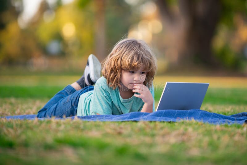 School Boy in Park Outdoor Doing School Homework. Child Using Laptop ...