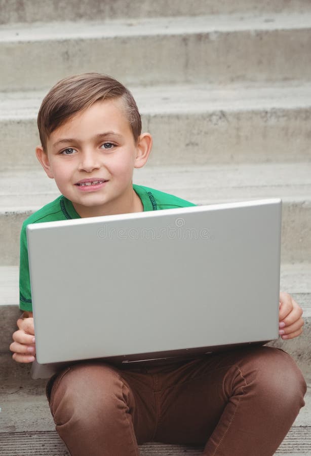 School Boy Sitting on Steps Using Laptop, Smiling and Learning Outdoors ...