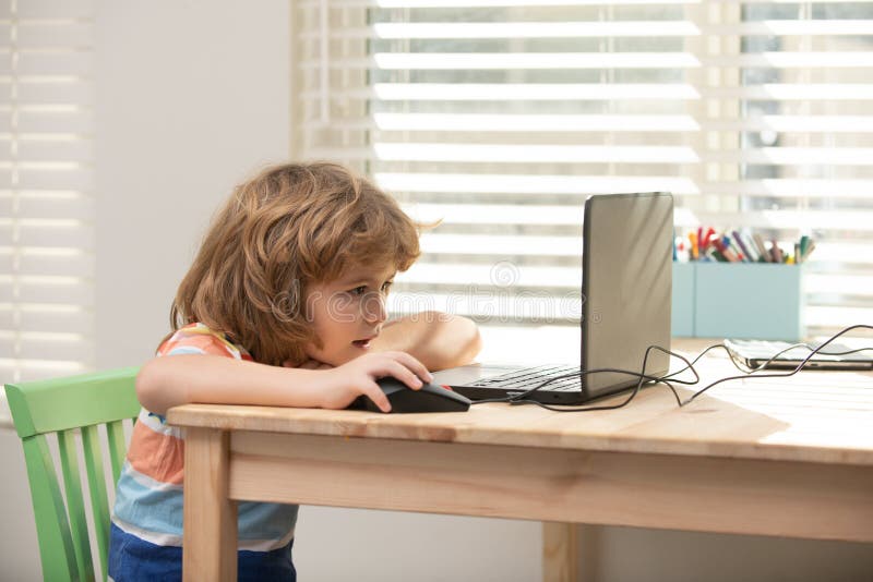 School Boy Sitting at the Table, Writing Homework or Preparing for the ...