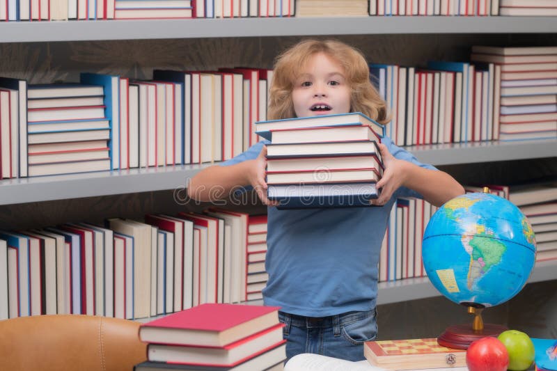 School Boy with Stack of Books in Library. Back To School Stock Photo ...