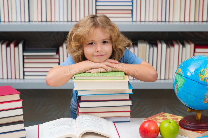 School Boy with Stack of Books in Library. Back To School Stock Photo ...