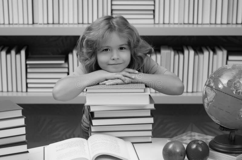 School Boy with Stack of Books in Library. School Child. Kid Boy from ...