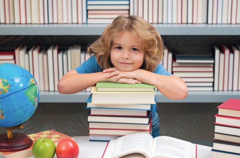 School Boy with Stack of Books in Library. School Child. Kid Boy from ...