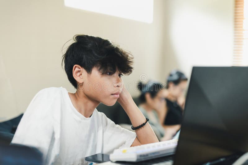 School Boy Using Laptop while Doing Schoolwork at Home Online Education ...