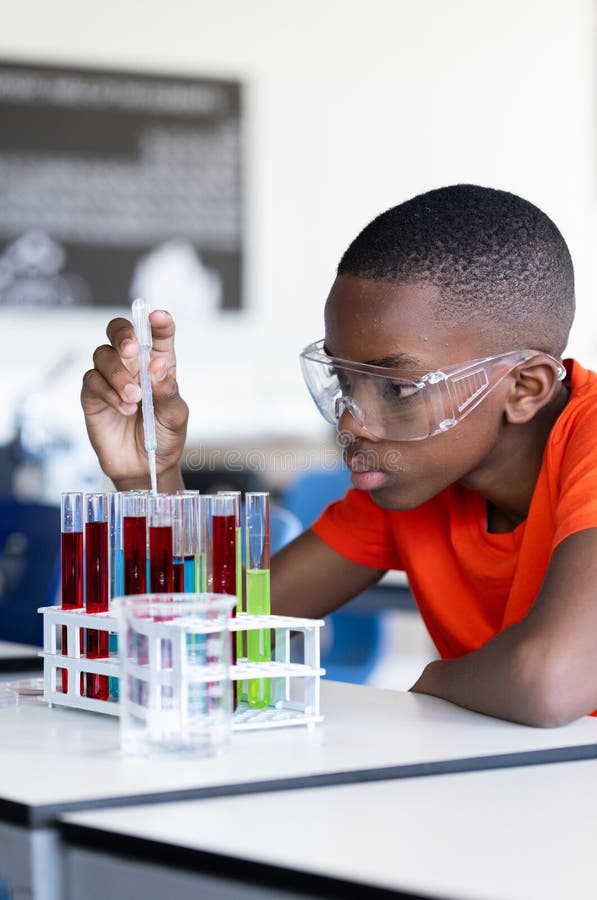 In School, Boy Using Pipette with Test Tubes in Science Classroom ...