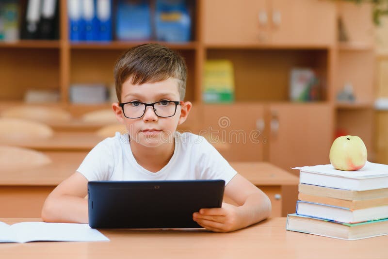 School Boy Using Tablet Compute in Classroom Stock Photo - Image of ...