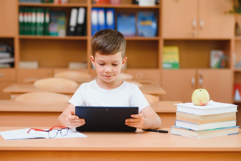 School Boy Using Tablet Compute in Classroom Stock Image - Image of ...