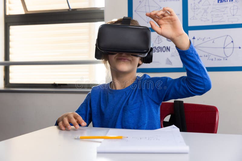In School, Boy Using Vr Headset while Sitting at Desk with Notebook ...