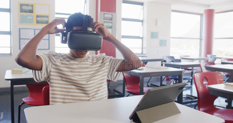 In School, Boy Using VR Headset and Tablet in Classroom, Exploring ...