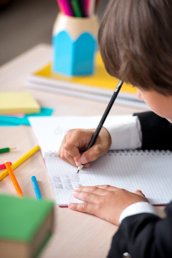 School Boy Writing in Notebook Stock Image - Image of library, table ...