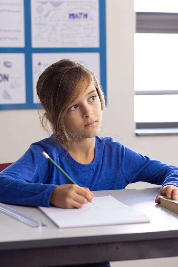In School, Boy Writing in Notebook, Concentrating on Her Work in ...