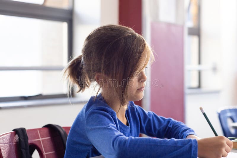 In School, Boy Writing with Pencil in Classroom, Concentrating on Task ...