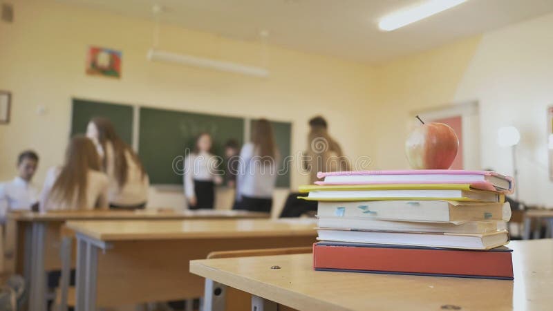 School Break in the Classroom. Books with Apple are on the Table ...