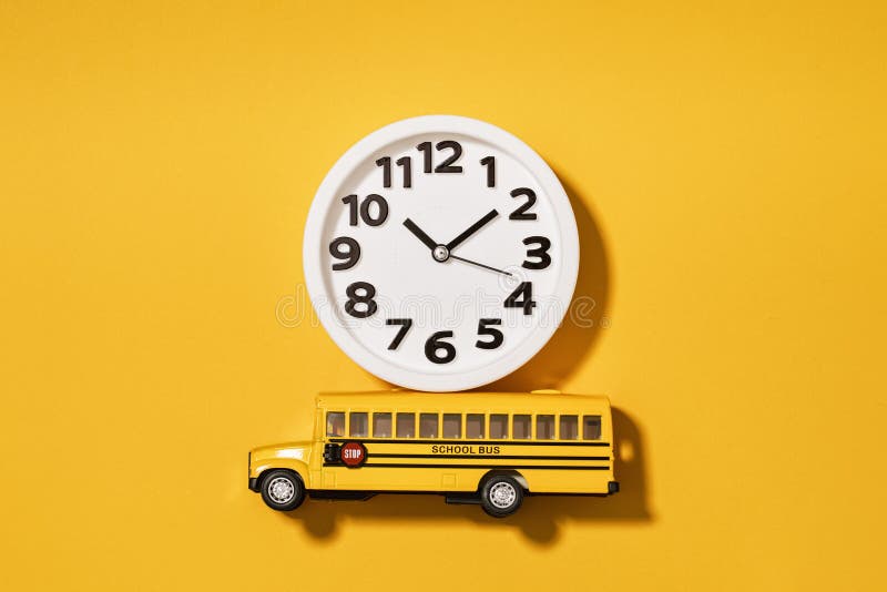 School Bus with White Clock on Top on Yellow Stock Photo - Image of ...