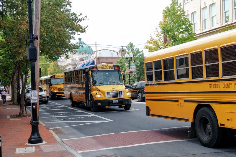School Buses Cross an Intersection in the Center of a Small Town ...