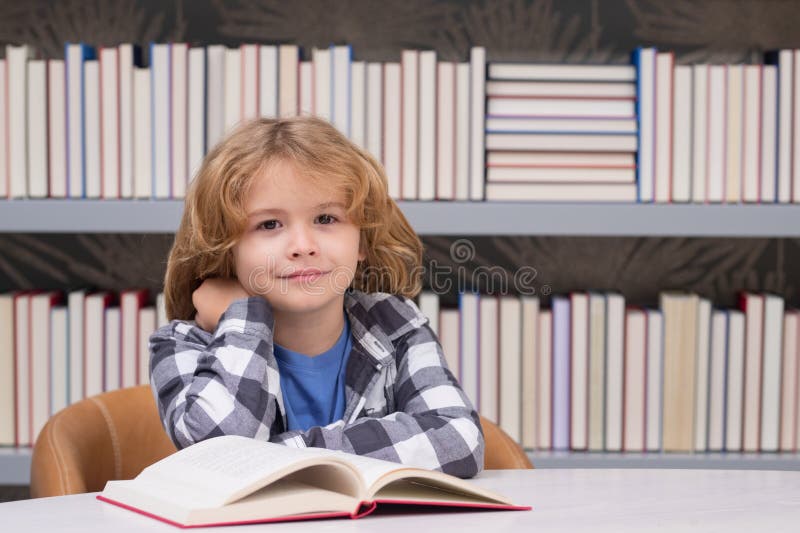 School Child Studying in School Library. Portrait of Child Reading in ...