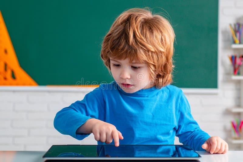 School Child with Tablet in School Classroom. Children Learning. Kids ...