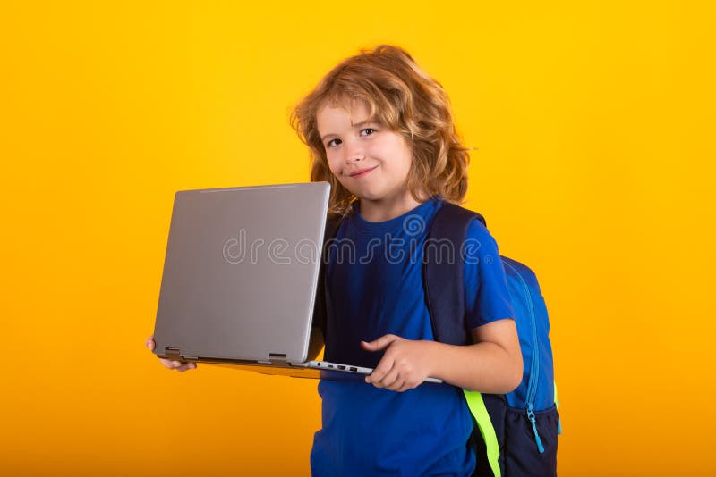 School Child Using Laptop Computer. Nerd School Kid Isolated on Studio ...