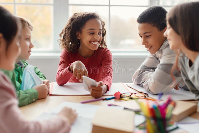 School Children Having Fun Using Smartphone during Break in Classroom ...