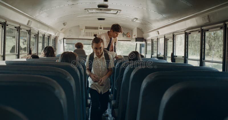 School Children Taking Seats in School Bus. Teenage Pupils Boarding on ...
