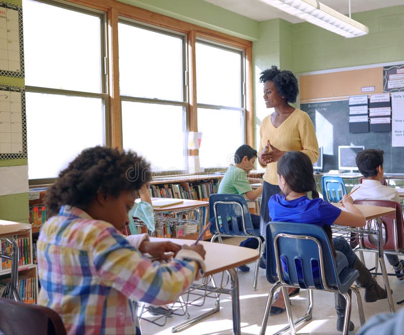 School, Children and Teacher in a Classroom while Talking To Kids To ...