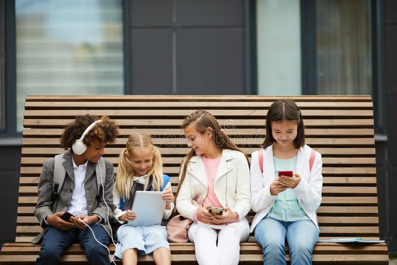School Children Using Mobile Phones Outdoors Stock Photo - Image of ...
