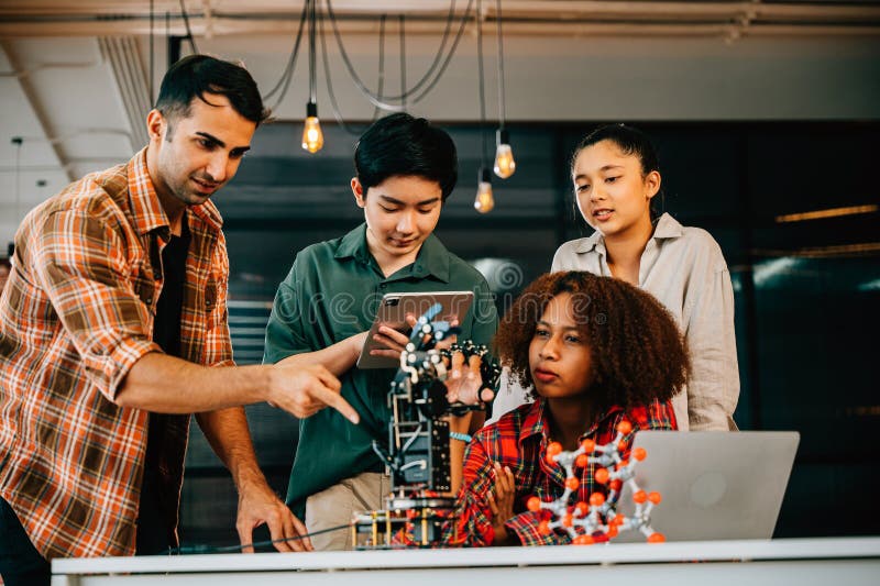 In a School Classroom a Group of Students and Teacher Learn with Fun on ...