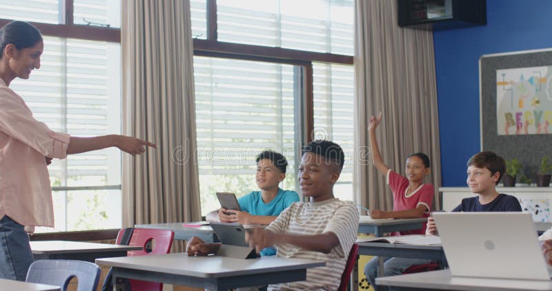 In School Classroom, Students Using Tablets and Laptops, Engaging with ...