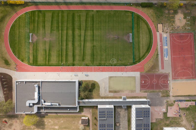 School Complex with Sports Fields and Urban Landscape - Aerial View ...